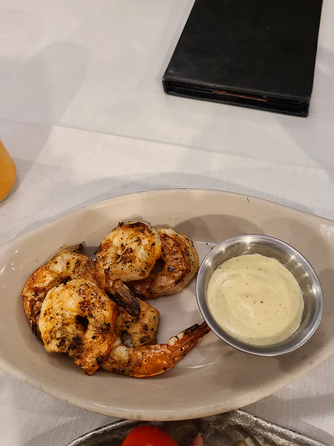 Shrimp that demand respect. These plump, perfectly seasoned crustaceans with their side of dipping sauce are appetizers that could steal the show.
