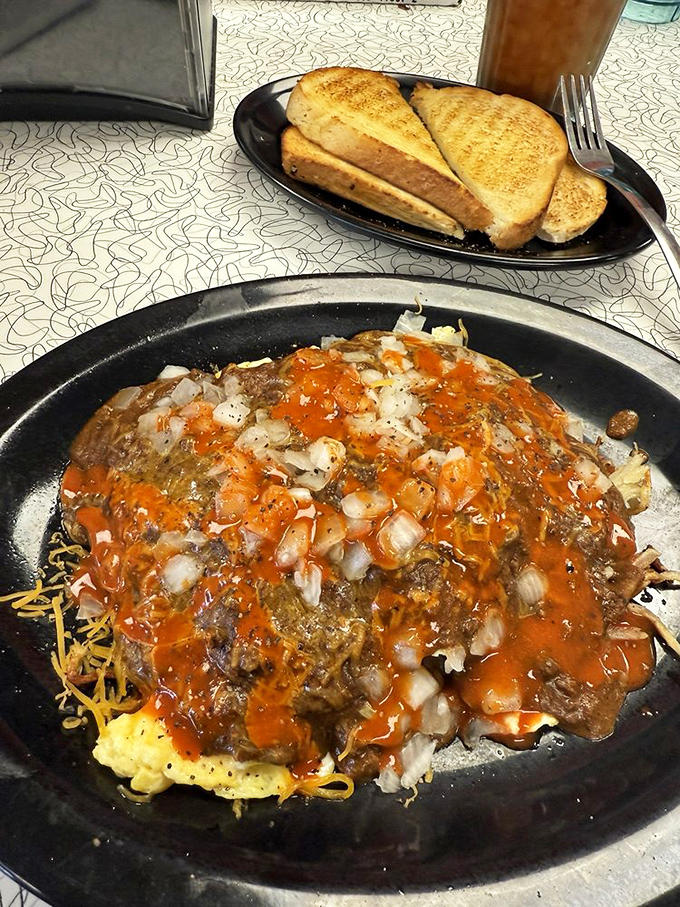 The infamous St. Louis Slinger - a glorious mess of hash browns, burger patty, eggs and chili that's both hangover cure and potential cause.