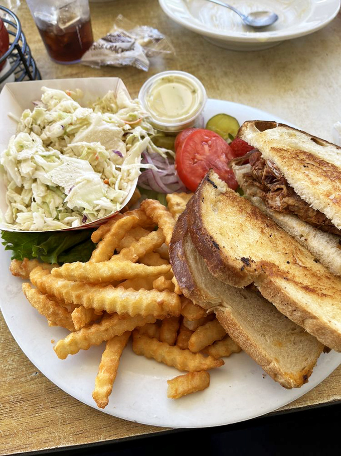 This isn't just a sandwich; it's architecture—a carefully constructed tower of flavor with coleslaw as the perfect counterpoint.