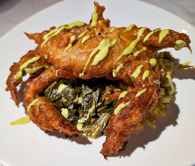 This soft shell crab wears its crispy batter like designer clothing, proving that sometimes the best accessories are savory sauces drizzled with artistic flair.