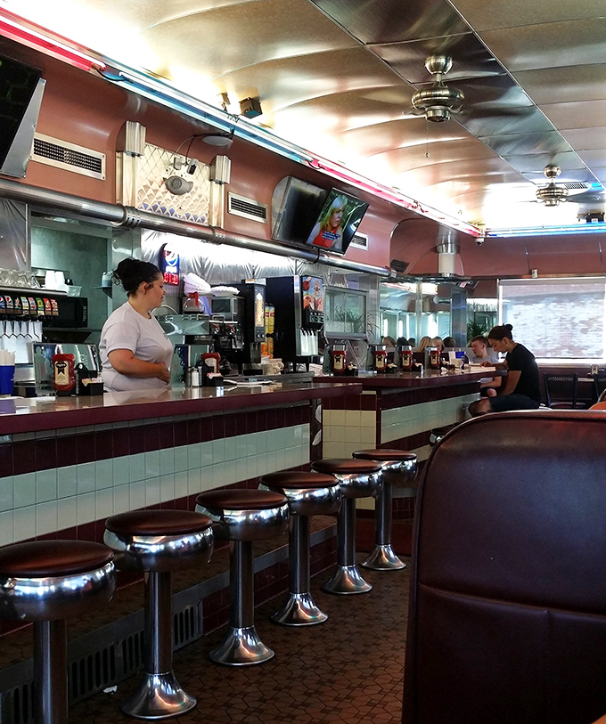 Where breakfast magic happens. The counter view offers front-row seats to the choreographed dance of short-order cooking that never gets old. 