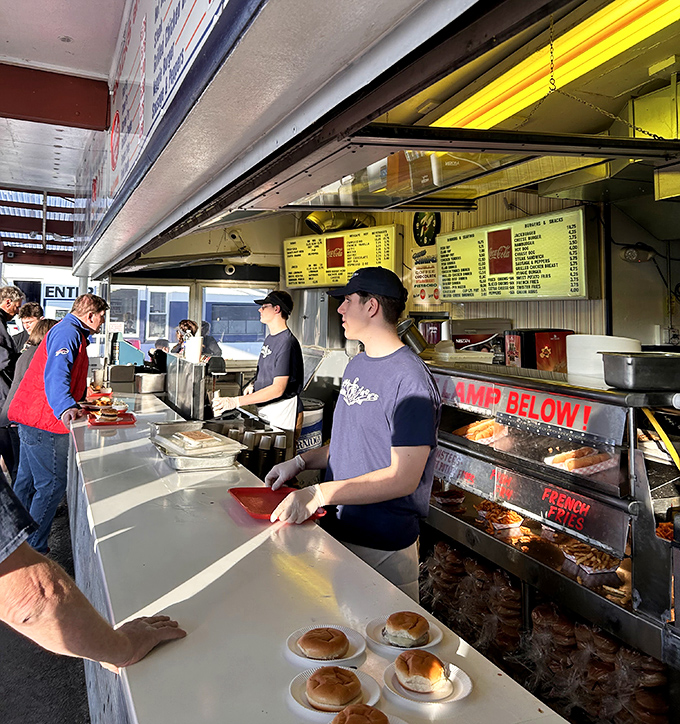 The kitchen crew works with the precision of a NASCAR pit team. These are the unsung heroes behind every perfect Jackburger.