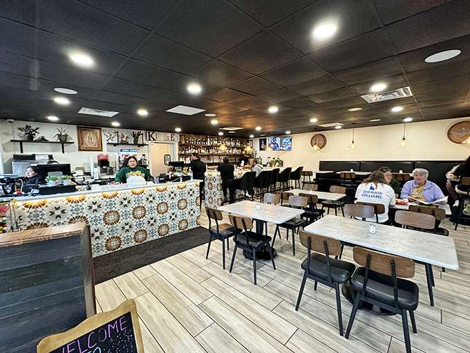The dining room's warm wood and tile work create the perfect backdrop for flavor adventures. That "welcome" sign speaks the universal language.