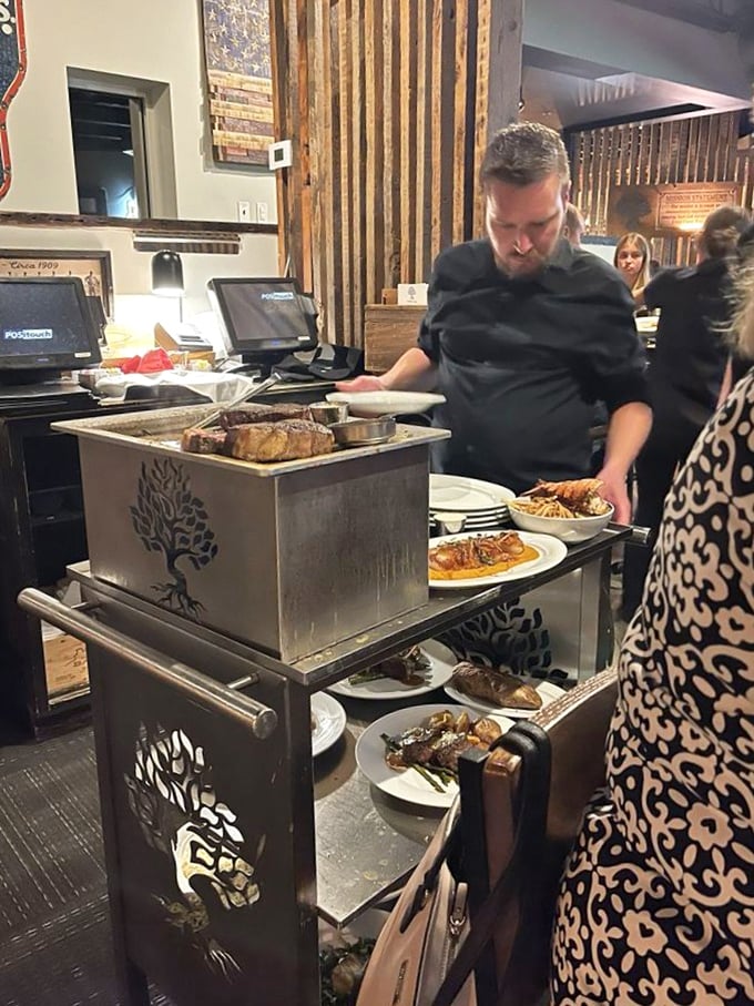 Culinary choreography in action as the chef prepares to send perfectly cooked steaks to their eagerly waiting destinations.
