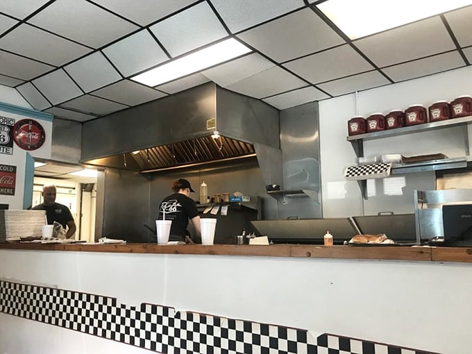 Behind the checkered counter trim, culinary magic happens—where roadside classics are prepared with care that transcends their humble origins.