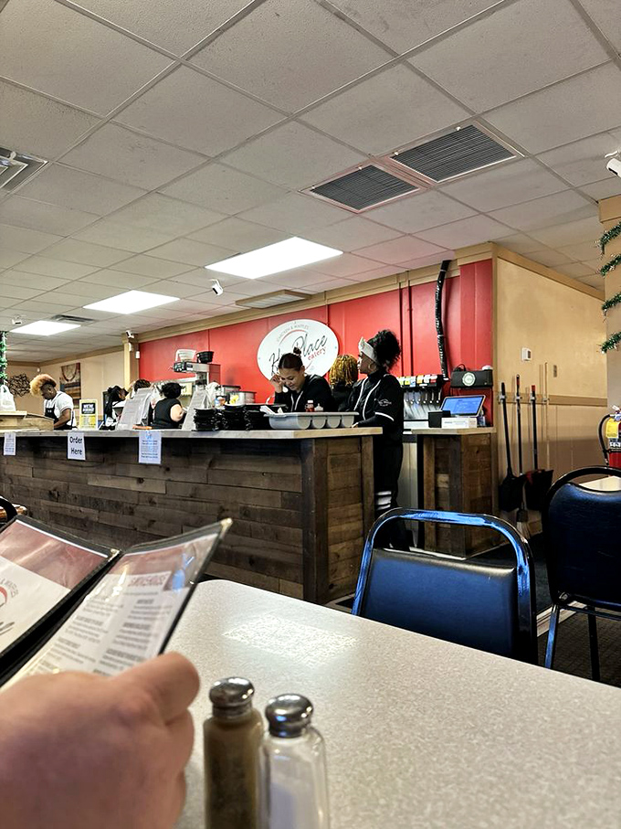 Behind the rustic wood counter, culinary magic happens with efficiency and friendly service that feels like home.