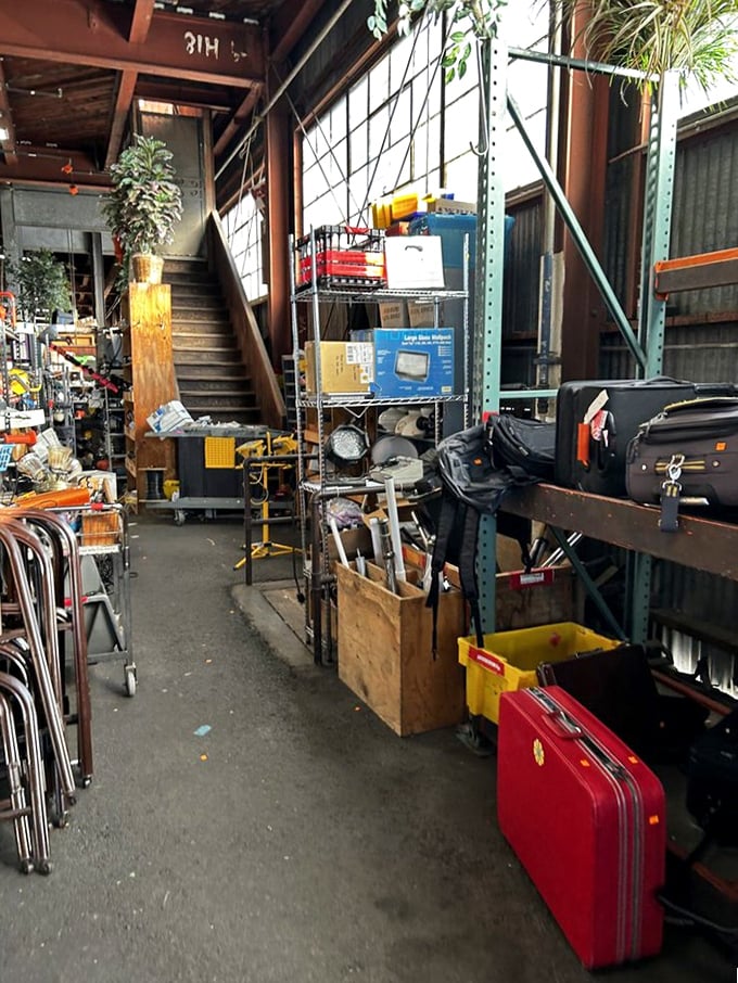 The stairway to somewhere interesting, flanked by the ghosts of luggage past. That red suitcase is begging for a road trip.