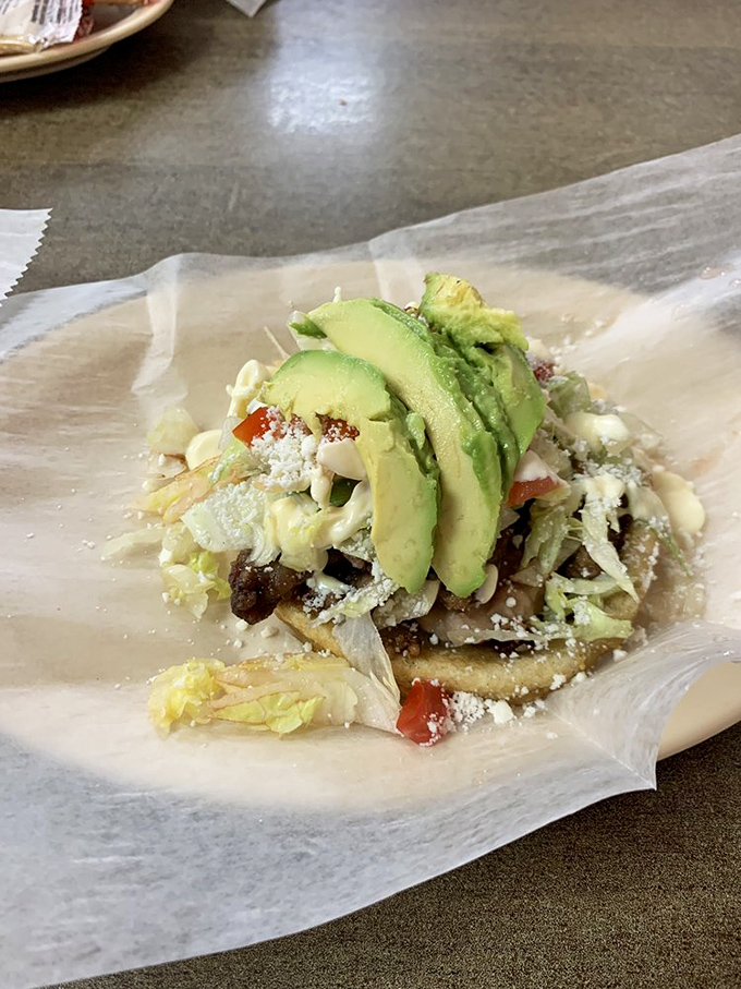 Sopes that serve as edible plates, topped with a mountain of lettuce, meat, avocado, and cotija cheese&mdash;like Mexican pizza but infinitely more interesting.