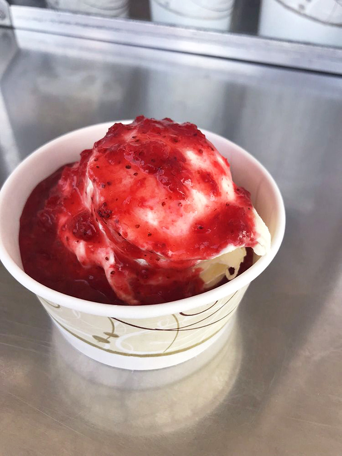 Strawberry topping cascades over vanilla custard like nature's perfect lava flow. Some geological wonders are meant to be eaten.