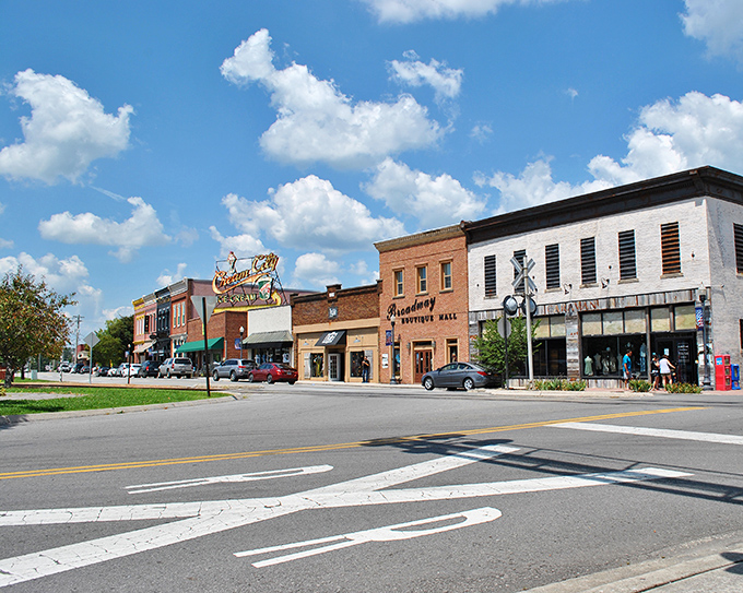 Historic downtown storefronts under Tennessee's blue skies, where window shopping doesn't lead to remorseful credit card statements.