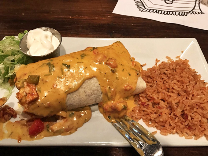 This burrito smothered in cheese sauce isn't just food&mdash;it's a warm, melty hug for your taste buds.