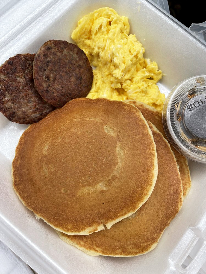 Pancakes so perfectly golden they belong in a breakfast hall of fame, paired with sausage and eggs for the complete morning experience.