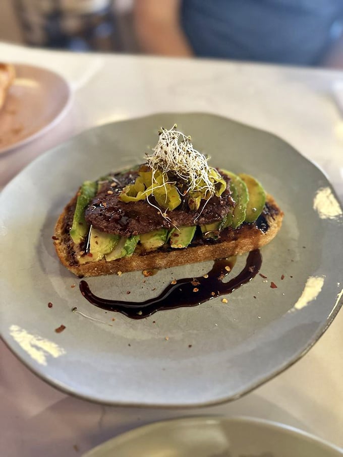 Avocado toast elevated: creamy avocado, savory toppings, and a balsamic drizzle that makes "basic" anything but.