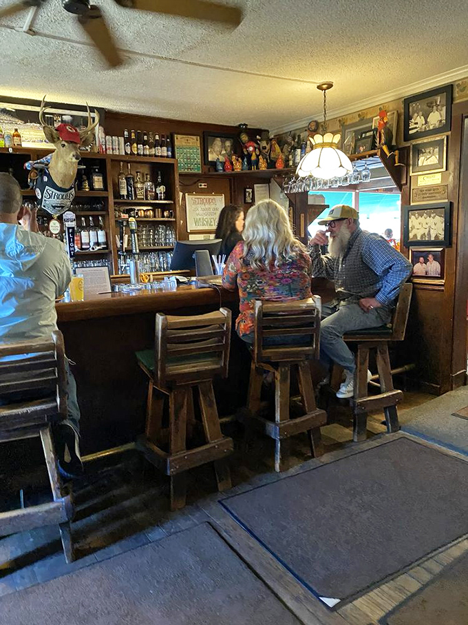 The bar area where stories flow as freely as the drinks, creating the perfect prelude to fried chicken bliss.