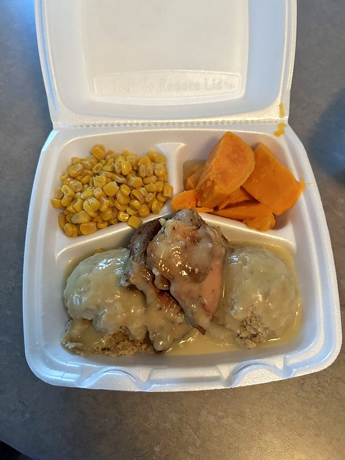 Comfort on a plate: chicken smothered in gravy, corn standing at attention, and sweet potatoes bringing their A-game.
