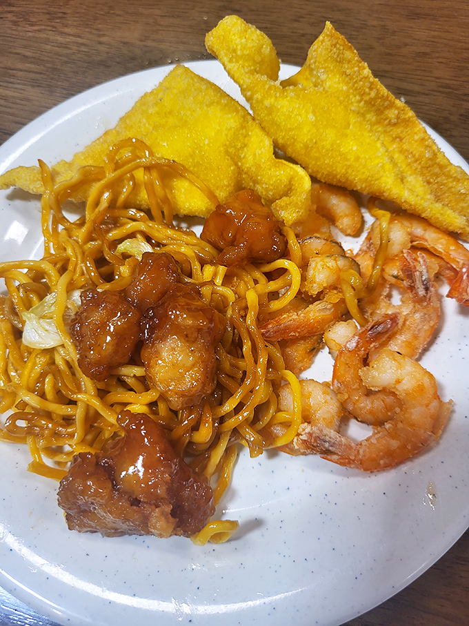 Lo mein noodles tangle with sweet glazed chicken while crispy wonton pieces stand at attention, ready for their moment of glory.