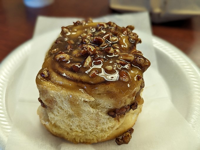 The cinnamon roll that makes you question everything you thought you knew about breakfast pastries. That caramel pecan topping isn't just a garnish&mdash;it's a commitment.