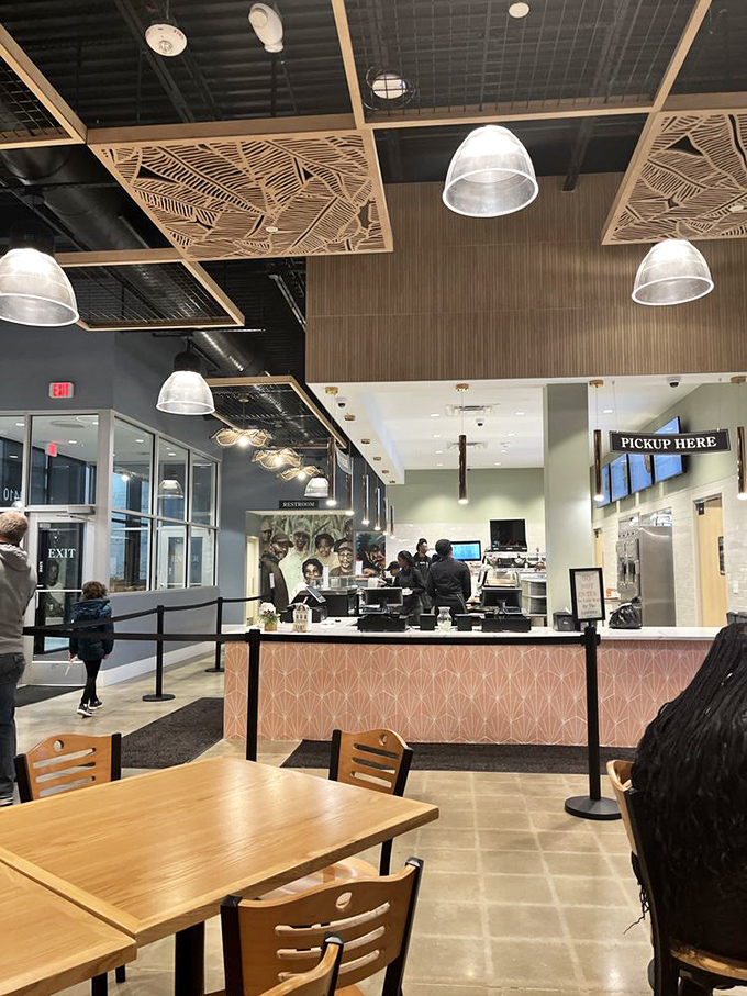 The counter where dreams come true and diets go to die. That geometric ceiling detail is almost as impressive as what's coming out of the kitchen.