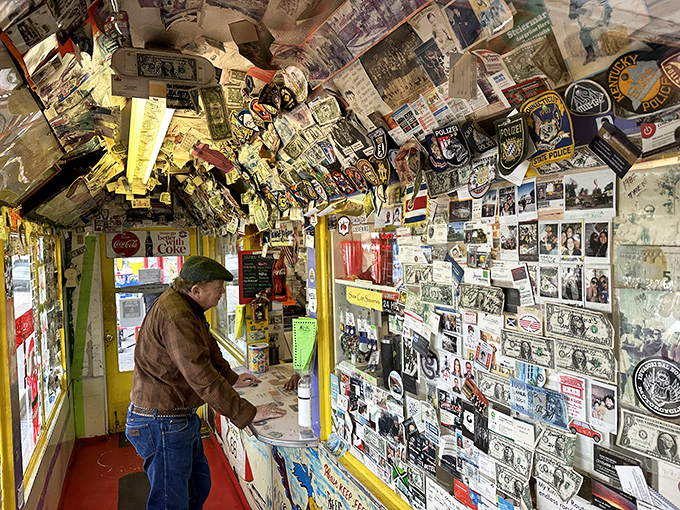 Money and memories share wall space in this time capsule of a counter, where every dollar bill tells a traveler's tale.