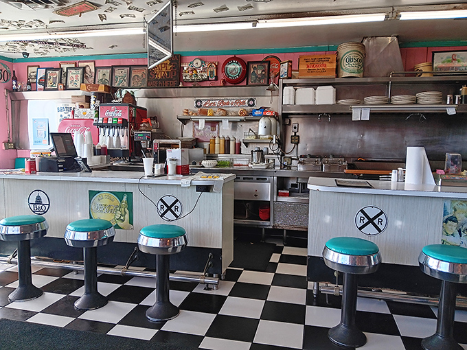 The counter where memories are served alongside breakfast. Those turquoise stools have heard more stories than a barber shop on Saturday morning.