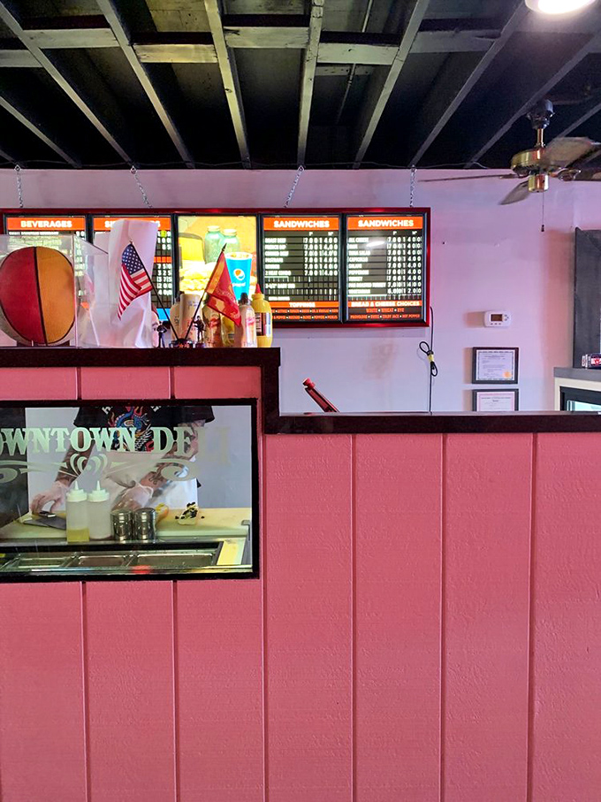 The ordering counter—where sandwich dreams are born and hunger goes to die. Notice the American flag—patriotism never tasted so good.