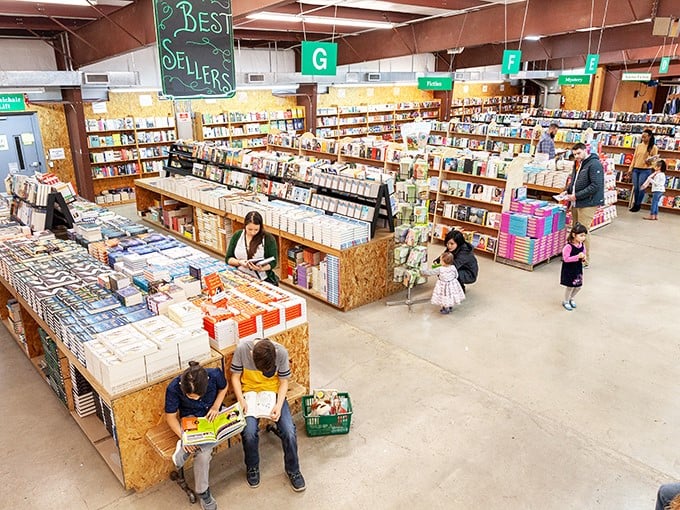 Book fair magic in action: families discovering literary treasures together. That boy's expression says he's just found the book that might change everything.