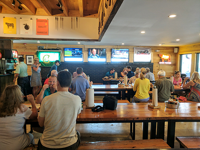 Happy diners savoring every smoky bite in this bustling barbecue haven where strangers become friends.