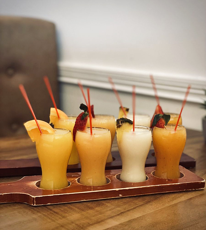 The smoothie flight board arrives like a tropical vacation in glassware&mdash;no passport required, just a sweet tooth and appreciation for fruit.