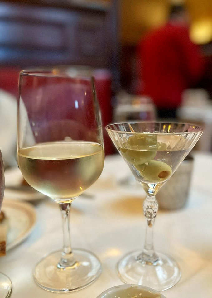 The perfect pairing: a chilled white wine and a martini with olives&mdash;liquid civilization in its highest form.