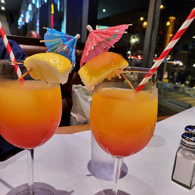 Sunset-colored cocktails complete with tiny umbrellas &ndash; because vacation mode activates regardless of whether you're actually on vacation.