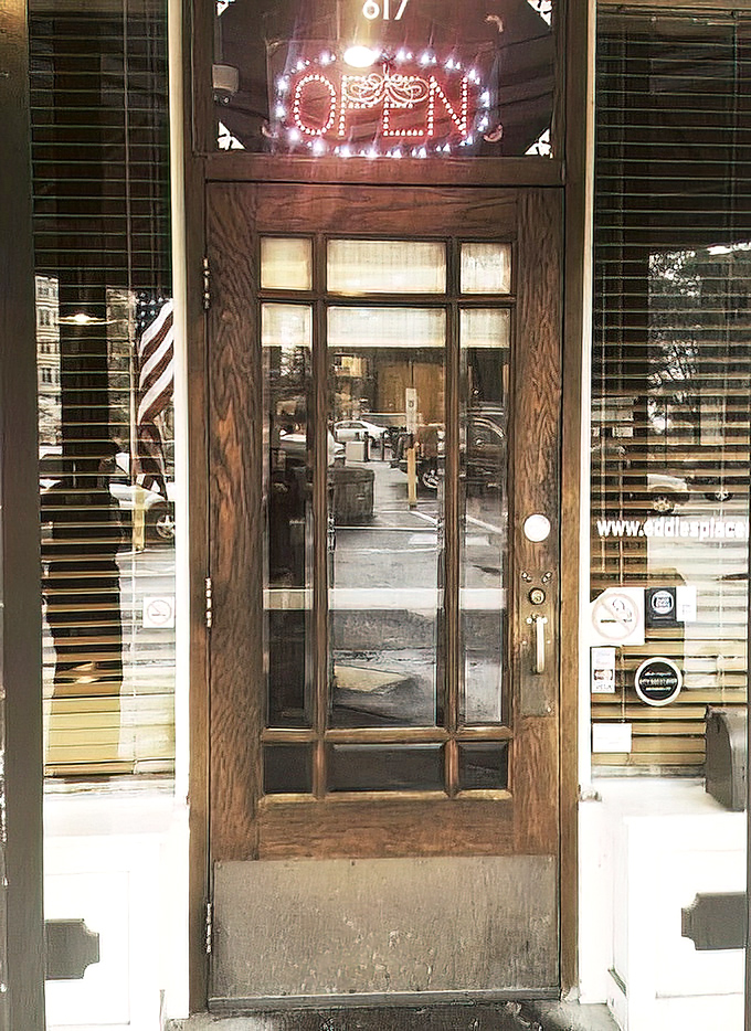 That "OPEN" sign glowing like a promise. The wooden door might as well say "Abandon diet, all ye who enter here."