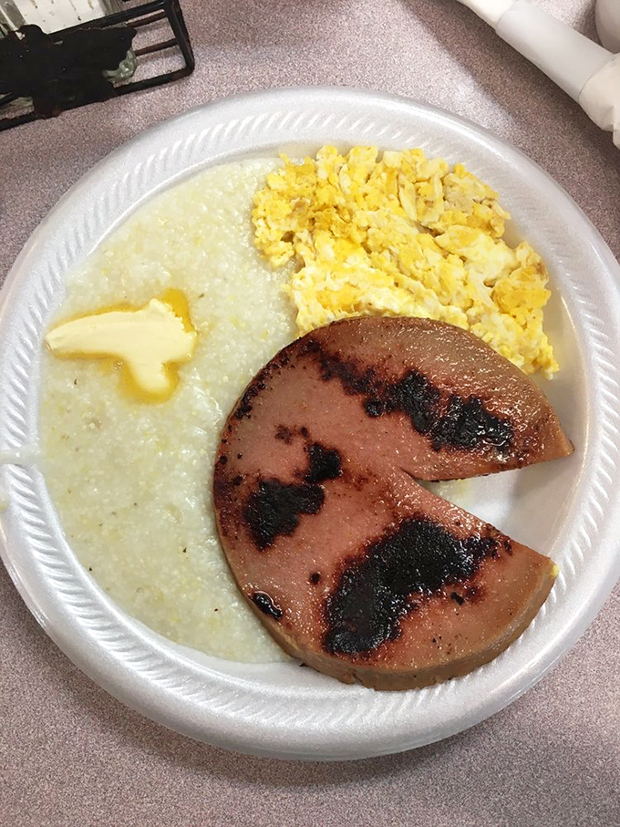 Grits, eggs, and ham having the breakfast meeting of champions. The butter melting on those grits is doing important work.