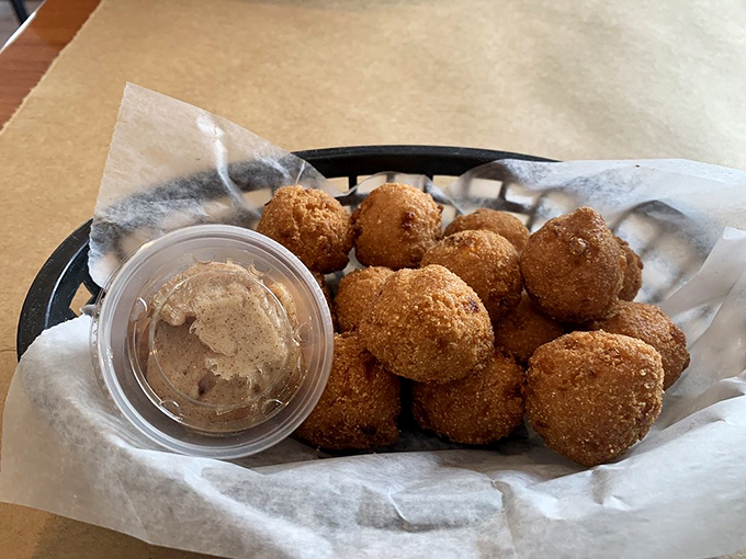 Golden-fried hush puppies with dipping sauce&mdash;crispy on the outside, fluffy on the inside, and impossible to eat just one.