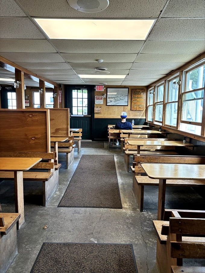 Quiet moments before the rush. These wooden benches have supported generations of seafood pilgrims seeking fried perfection.