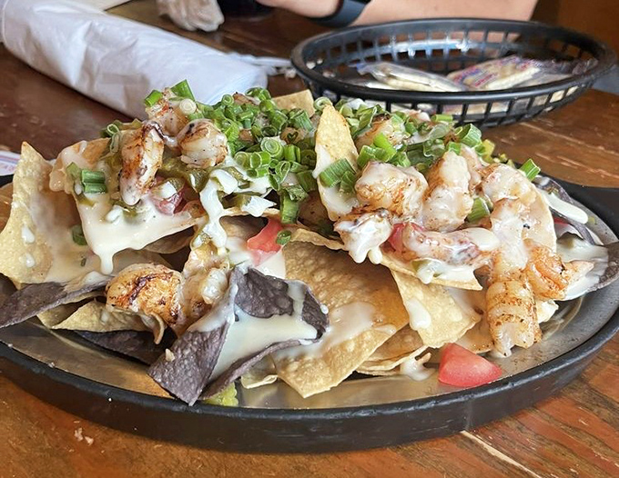 Seafood nachos that render conversation impossible. When chips become merely vehicles for delivering perfectly seasoned shrimp, something magical has happened.