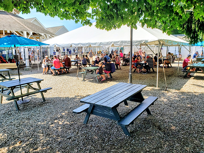 Al fresco dining at its finest – where picnic tables under white tents create the perfect summer setting for seafood indulgence.
