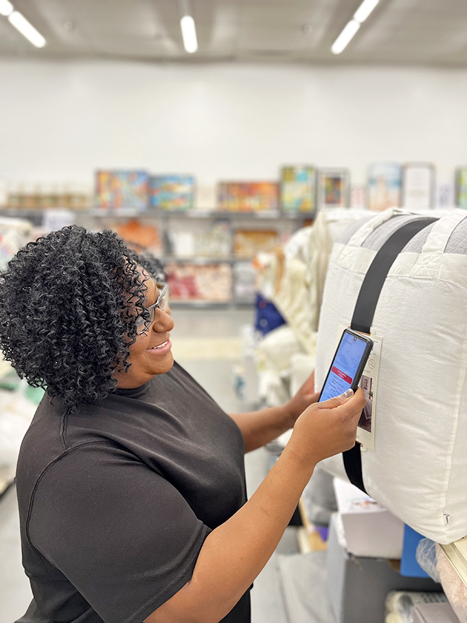 The scanning strategy in action. Smart shoppers use their phones to check retail prices, multiplying the satisfaction when they score a genuine deal.