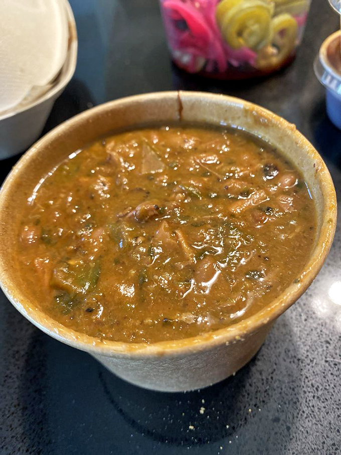 A bowl of beans that's been simmering alongside the smoker, absorbing all those magical meat drippings and turning into something transcendent.