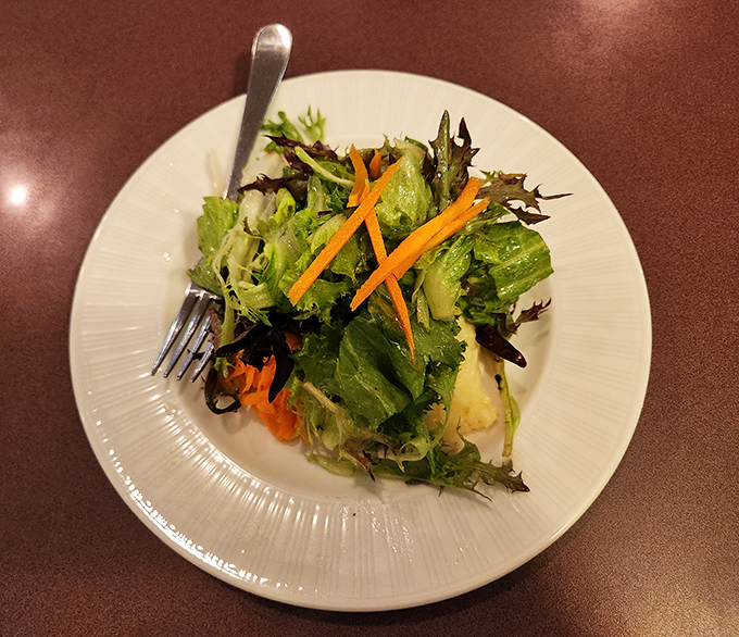 Even the salad gets the royal treatment. Those carrots standing at attention like they know they're in the presence of culinary greatness.