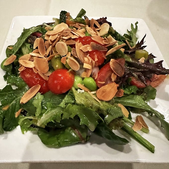 A salad that doesn't apologize for being healthy. Those toasted almonds add the perfect crunch to complement the tender greens.