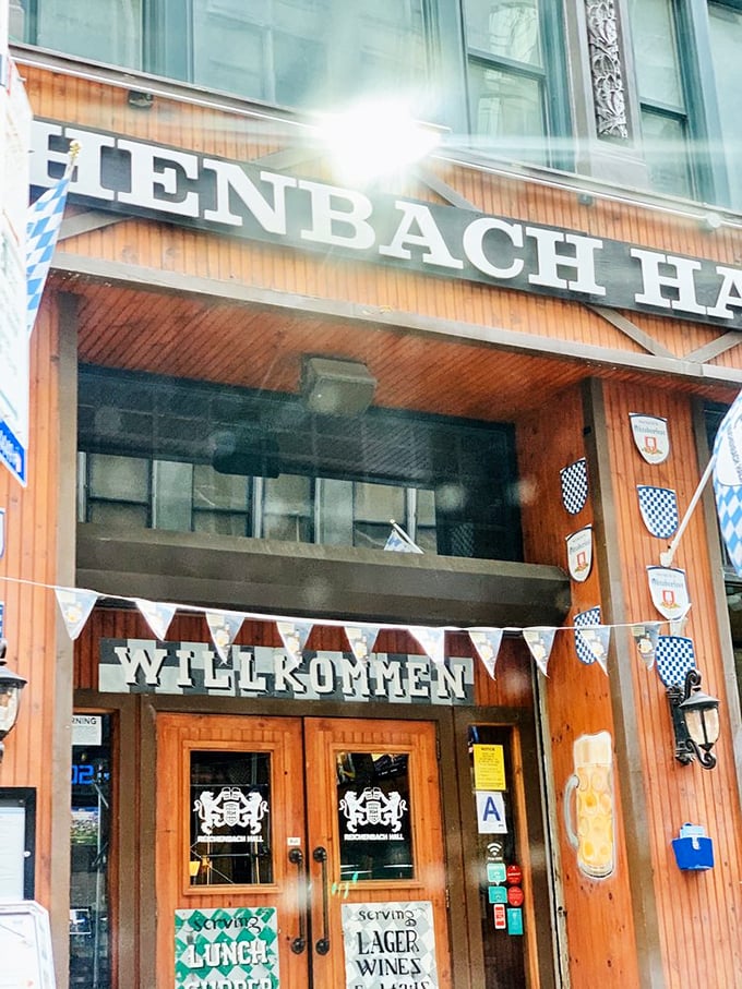 The sign promises Bavarian delights within, while blue and white flags flutter like they're cheering you on to culinary victory.