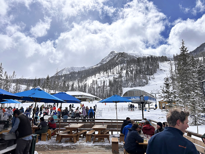 Winter transforms the deck into a snow globe come to life, where steaming plates arrive to fortify skiers between runs.