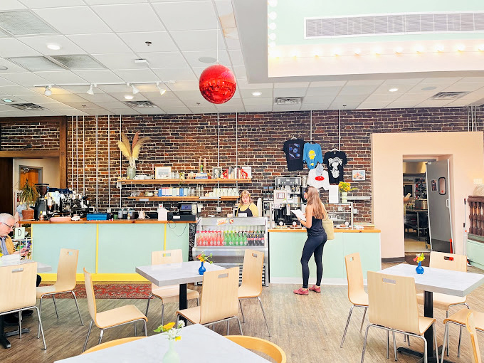 Clean lines, bright colors, and that signature red disco ball create an atmosphere that's both nostalgic and thoroughly modern.