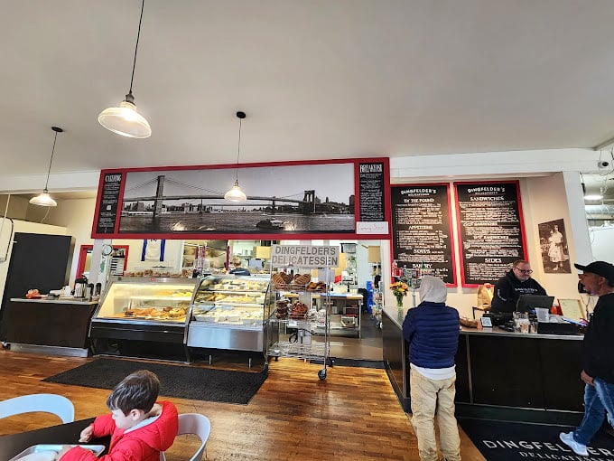 Where magic happens: the open kitchen design lets you witness the choreography of deli preparation in all its gloriously authentic splendor.