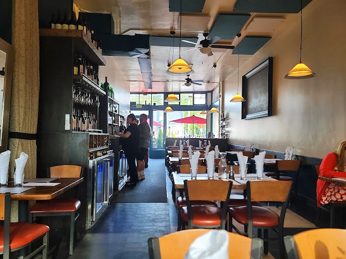 The narrow dining room creates an intimate experience where every table feels special. Like dining in someone's stylish Italian home, if that home had exceptional lighting.