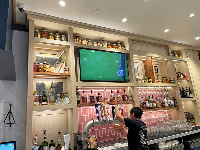 Behind this modern bar setup sits a treasure trove of spirits, each bottle promising its own unique contribution to happiness.