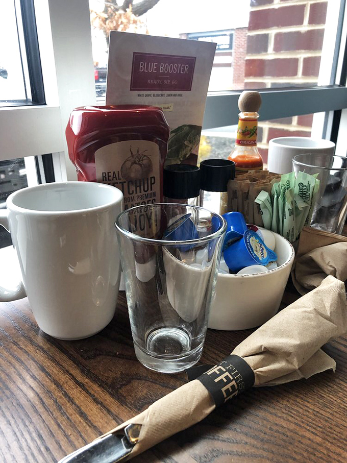 The table setting speaks volumes: real ketchup, hot sauce options, and the promise of coffee refills&mdash;small details that build breakfast bliss.