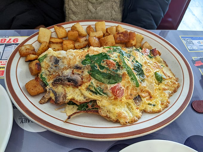This veggie omelet doesn't just eat its greens&mdash;it celebrates them. Spinach, tomatoes, and mushrooms having a party, with crispy home fries as the perfect plus-one. 