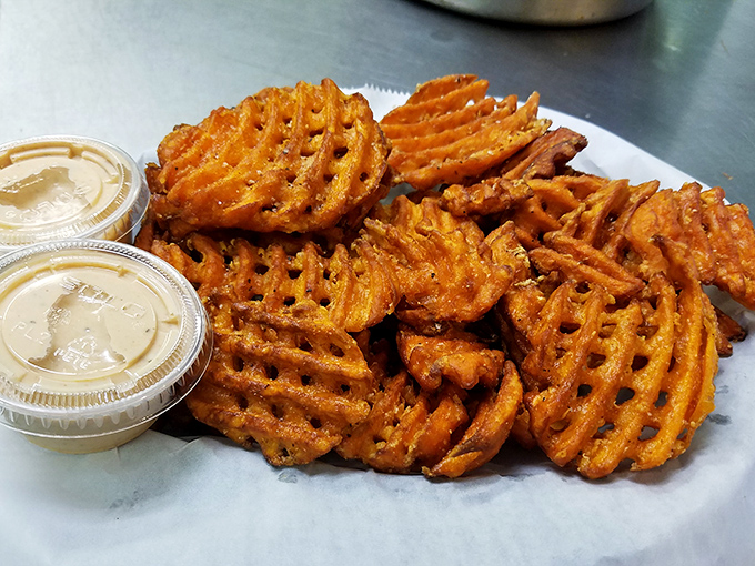 These waffle-cut sweet potato fries aren't just sides&mdash;they're main attractions with supporting roles, dressed in spices that would make Broadway jealous.