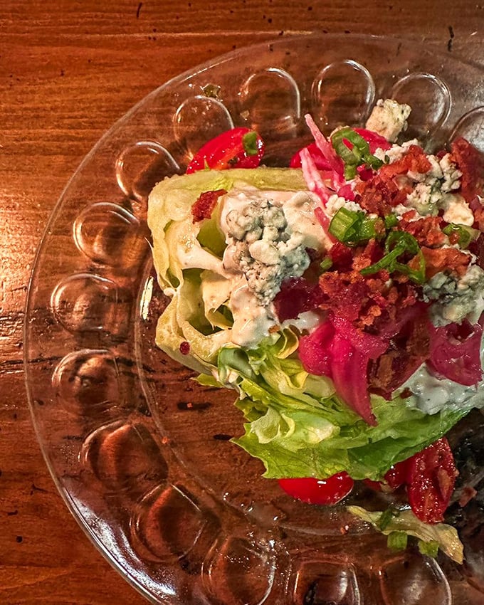 This wedge salad isn't just a prelude to steak&mdash;it's a masterpiece of contrasts with crisp lettuce, blue cheese, and bacon that demands respect.
